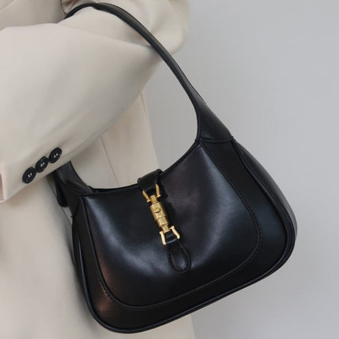 Black Classic Curved Leather Handbag with Signature Buckle Closure ...